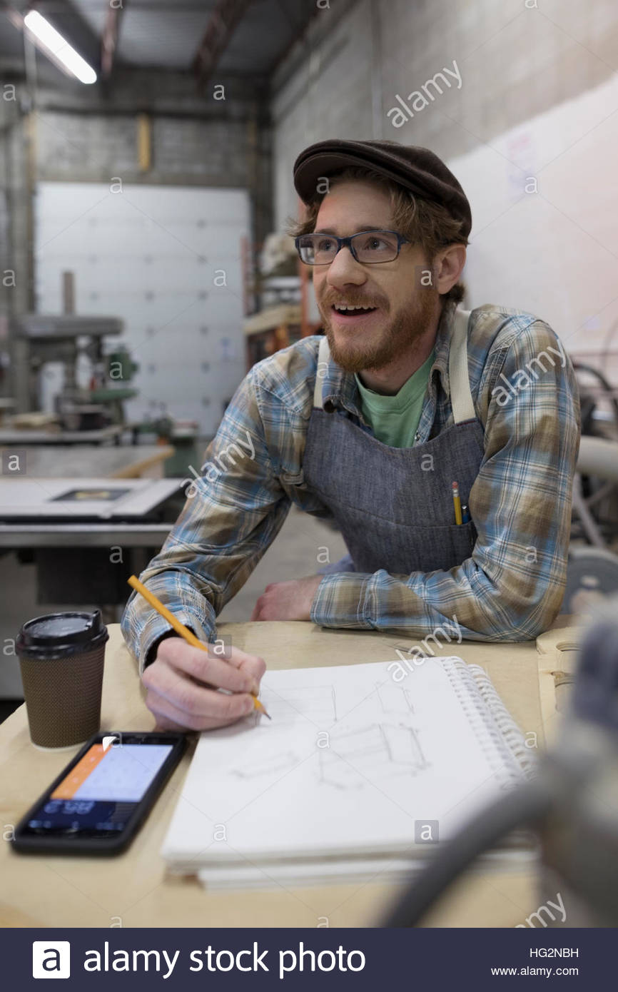 Male carpenter designing furniture in workshop Stock Photo - Alamy
