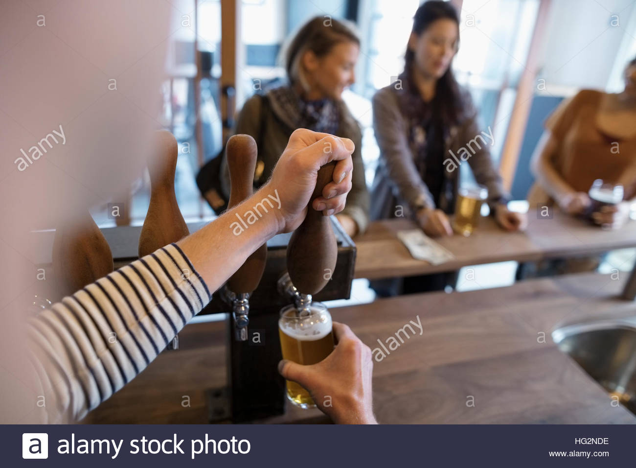 Woman serving a man beer hi-res stock photography and images - Alamy