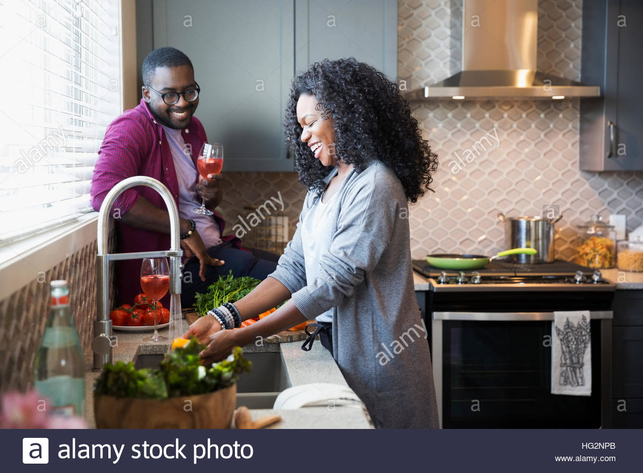 Two woman standing sink talking hi-res stock photography and images - Alamy