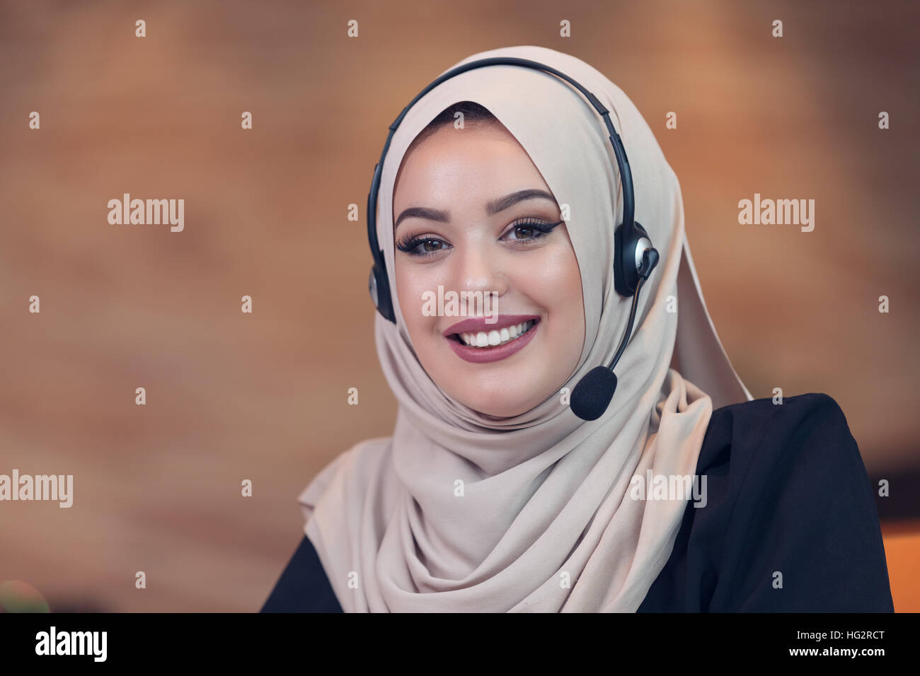 Beautiful phone operator arab woman working in startup office Stock ...