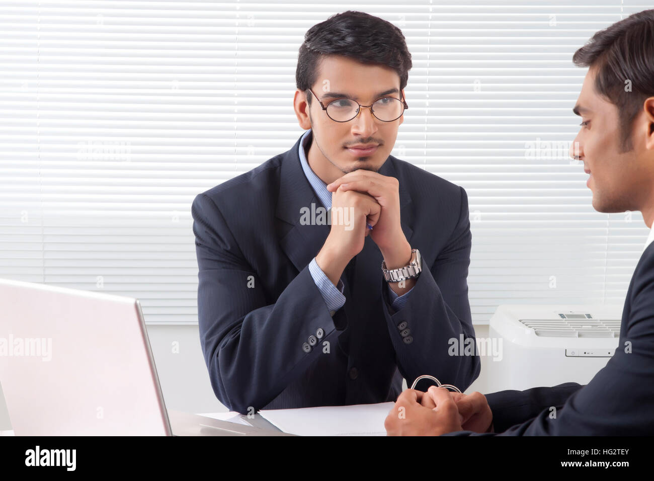 Young professional man listening patiently to another professional man ...