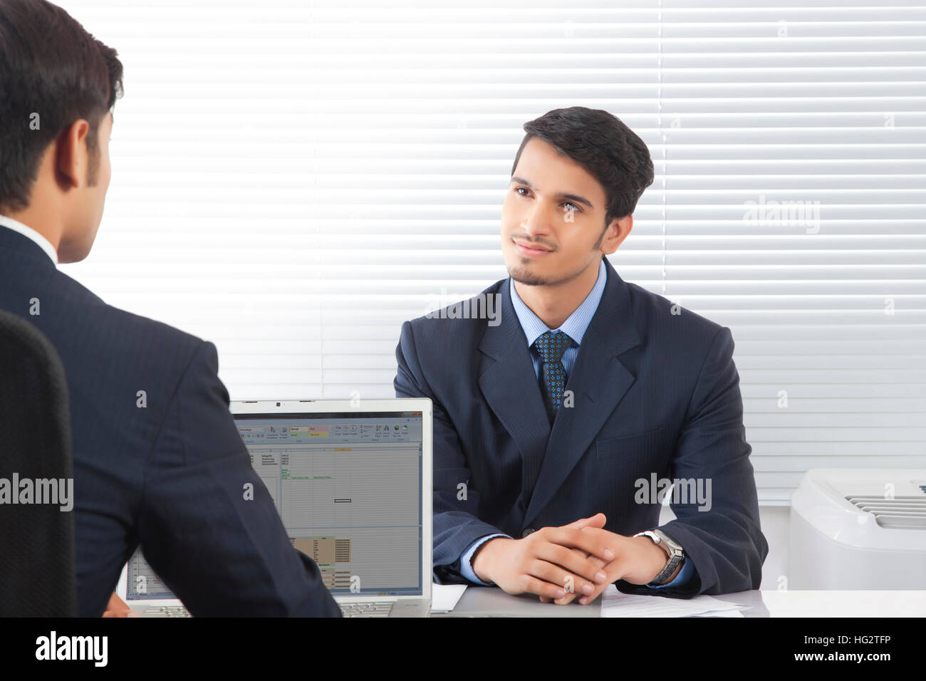 Two businessmen talking to each other hi-res stock photography and ...