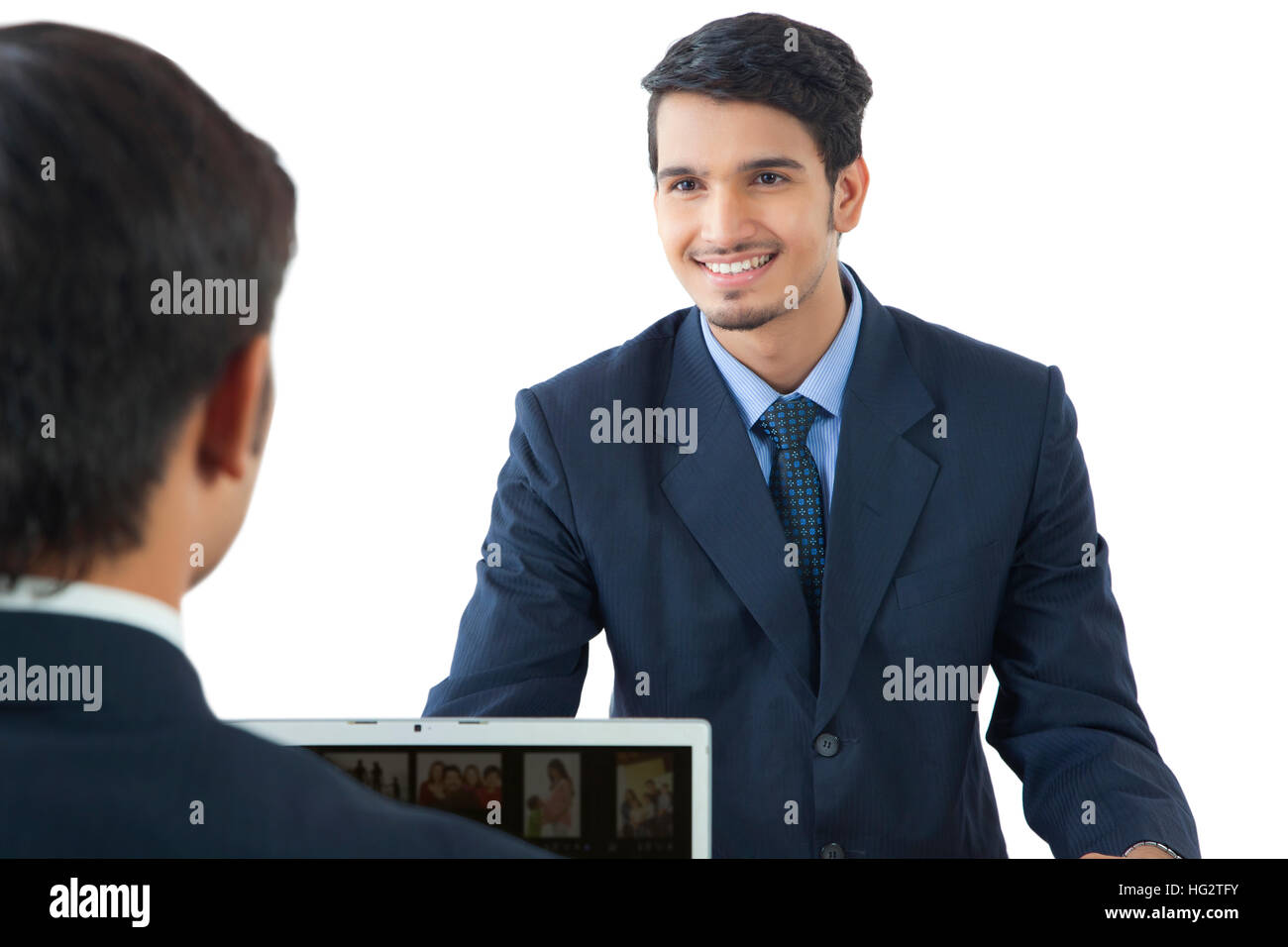 Two businessmen sitting in office which laptop computer on desk Stock ...