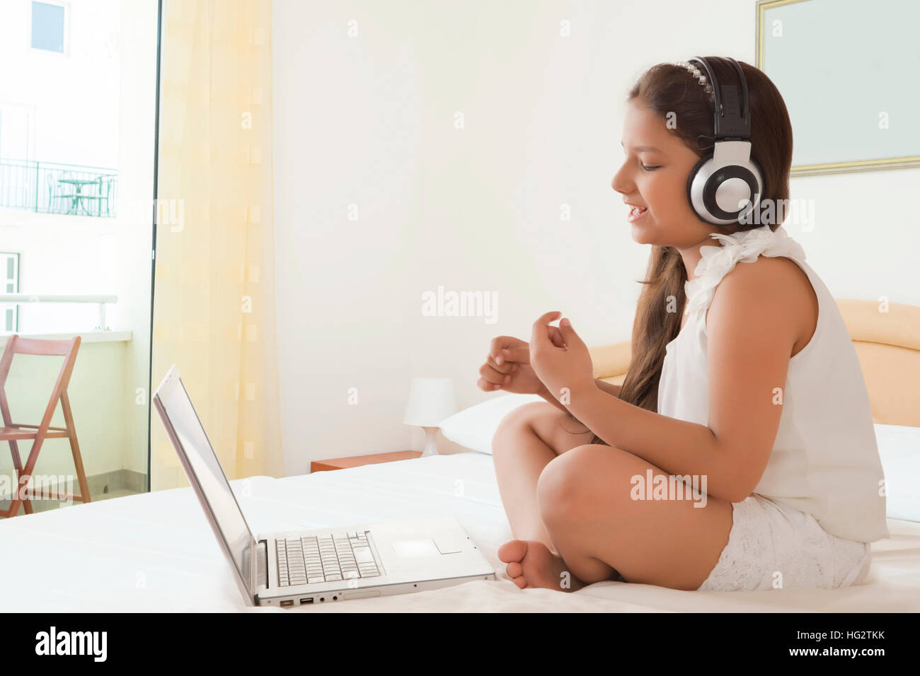 Girl listening music on laptop computer Stock Photo - Alamy