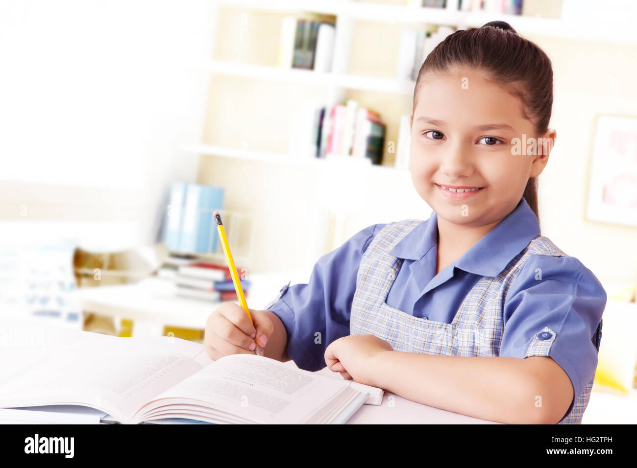 Girl in school uniform doing hi-res stock photography and images - Alamy