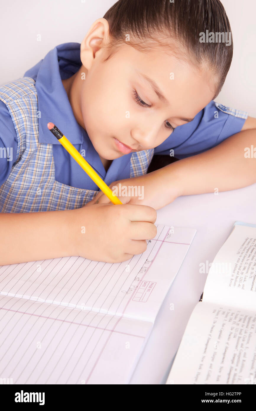 Girl in school uniform doing hi-res stock photography and images - Alamy