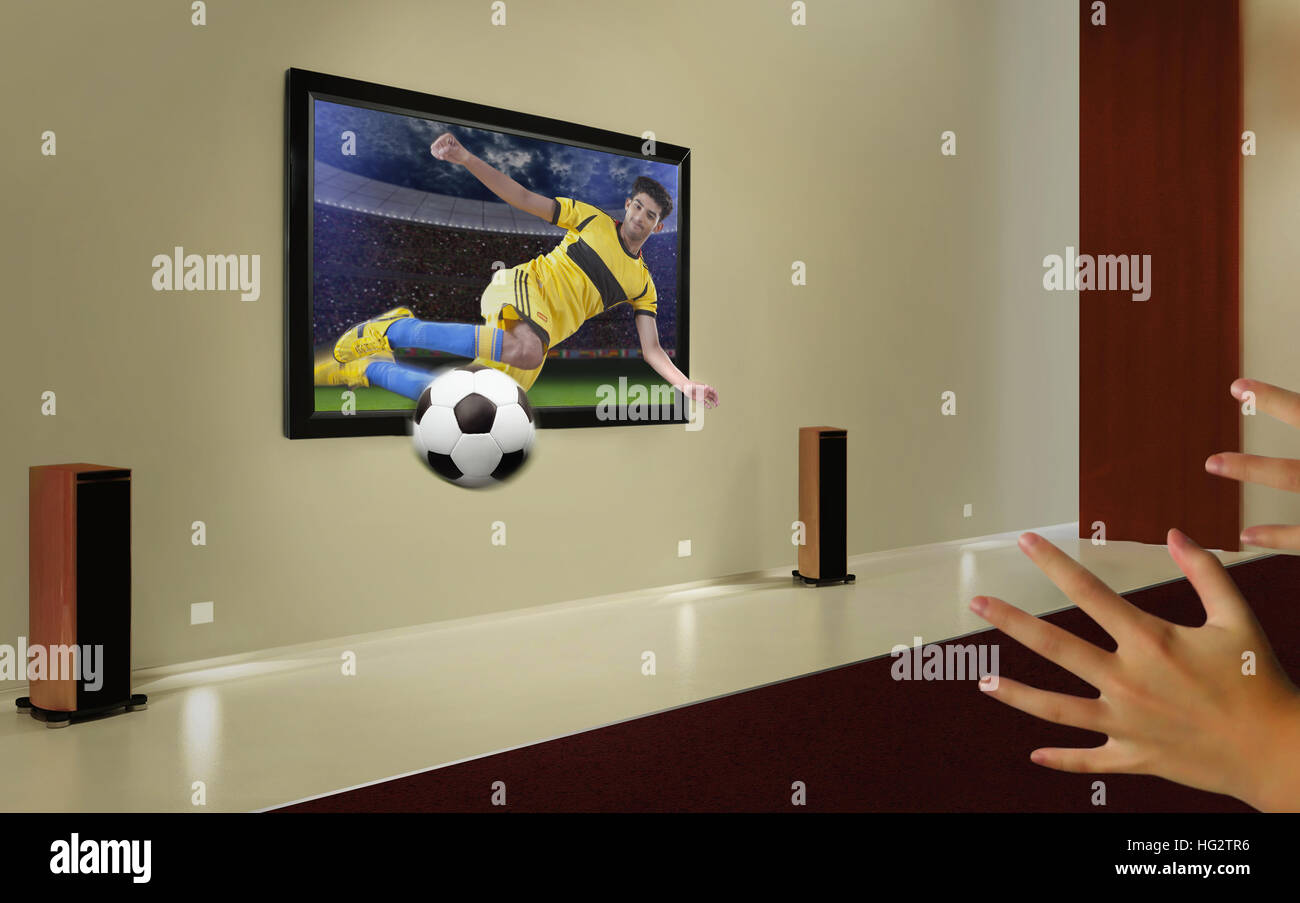 Caucasian soccer player coming out of television set Stock Photo - Alamy