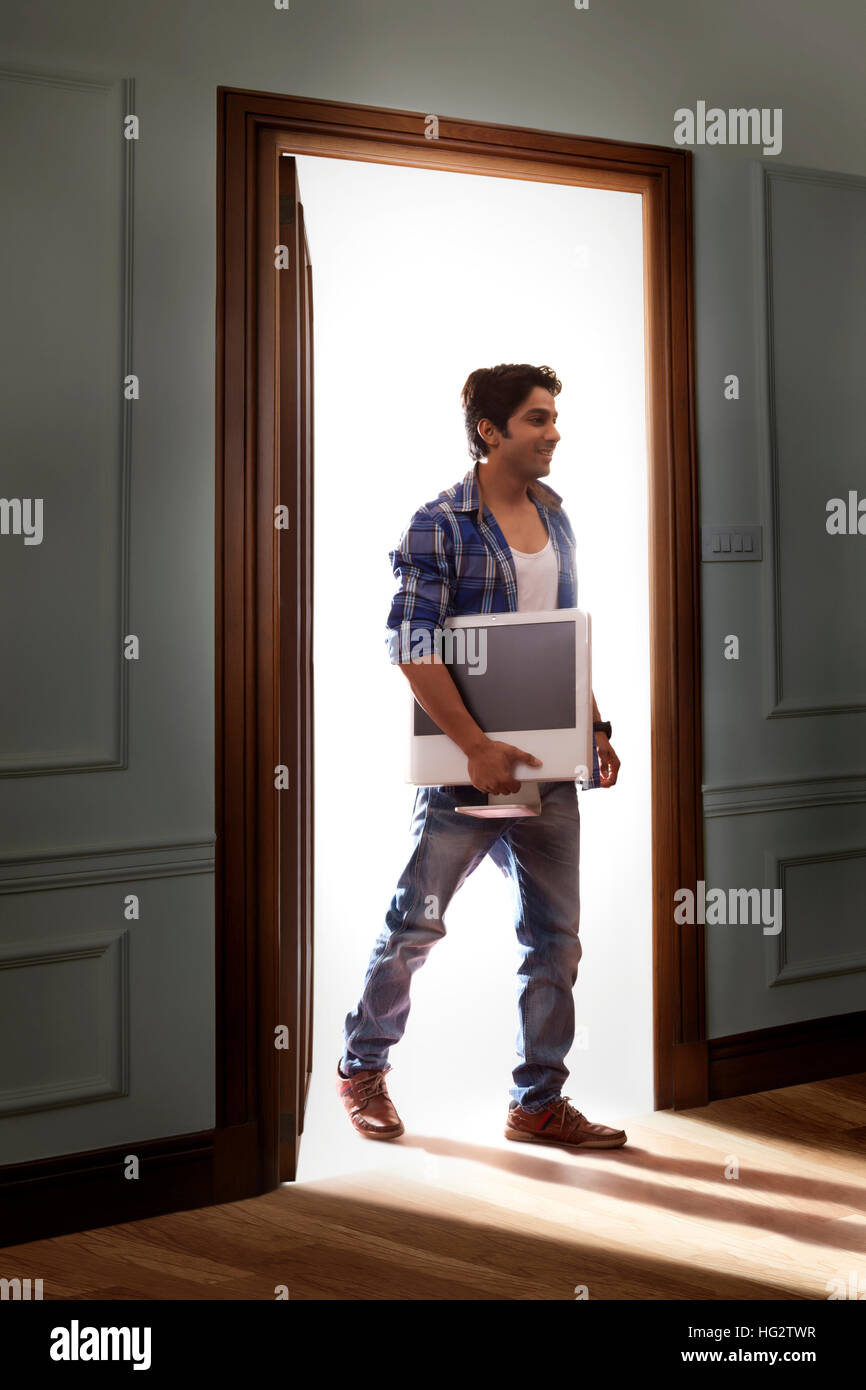 young man carrying laptop Stock Photo - Alamy