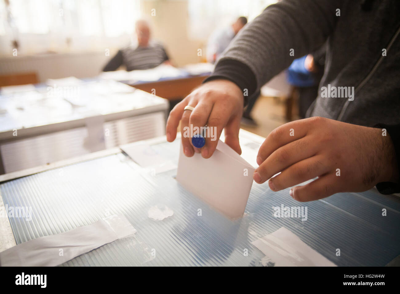 A person casts her ballot during voting for parliamentary elections at ...
