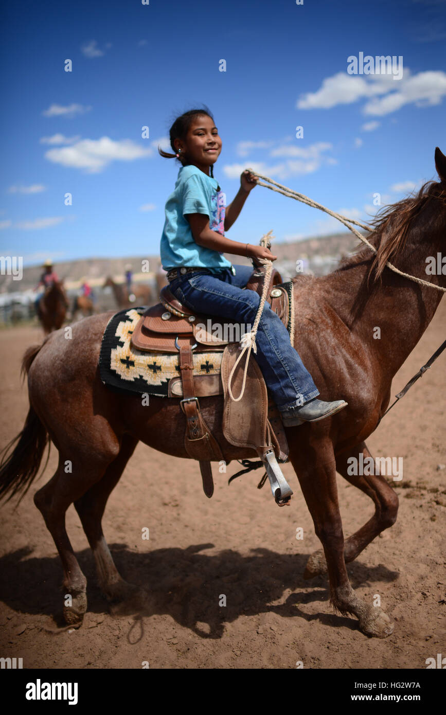 Cute young native american girl riding her horse during Navajo Nation ...
