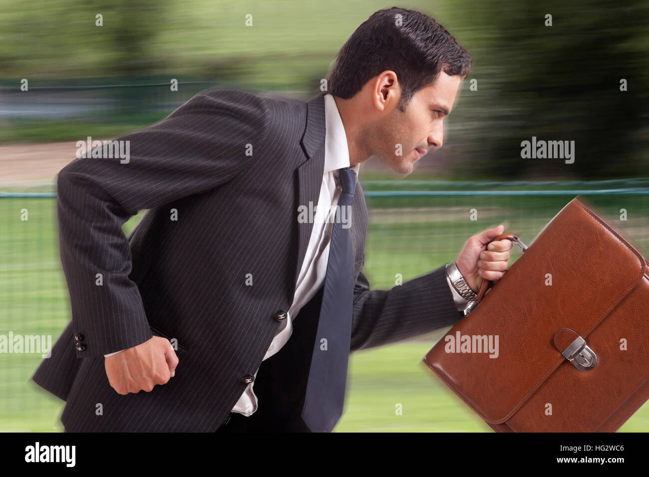 Businessman running with briefcase Stock Photo - Alamy