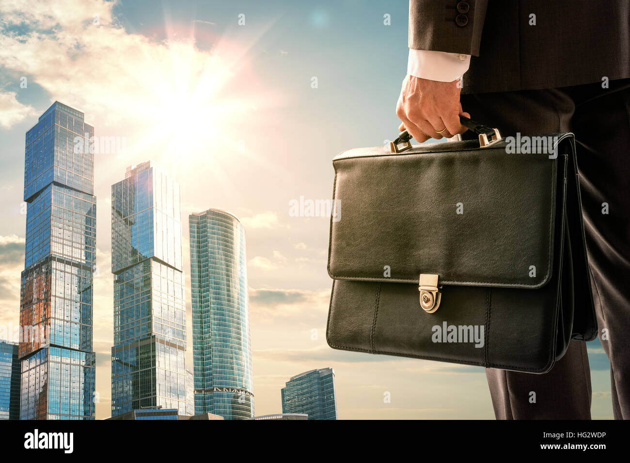 Businessman standing with back against city Stock Photo - Alamy