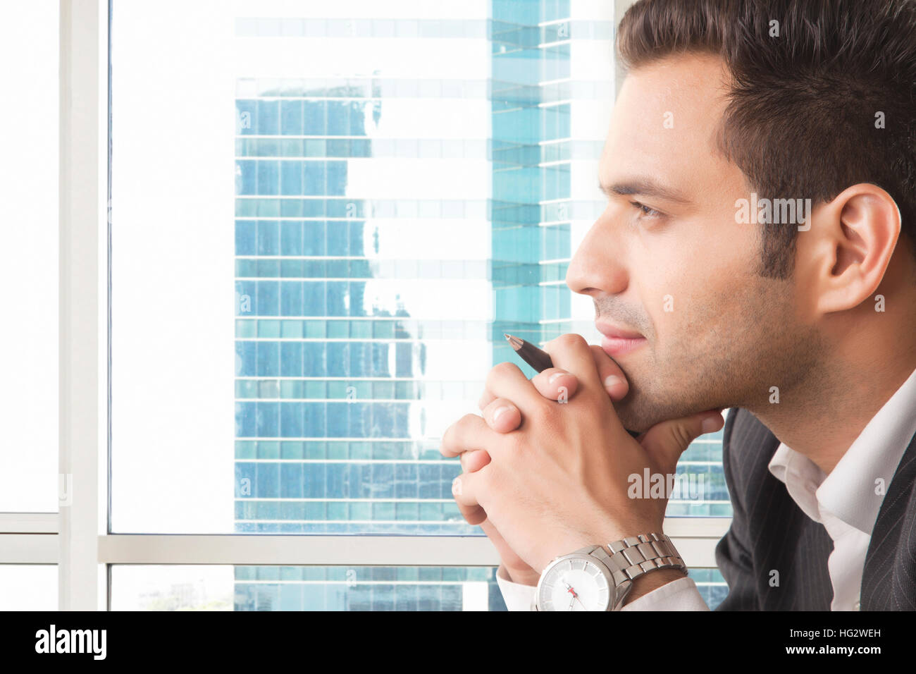 Portrait of a businessman thinking Stock Photo - Alamy
