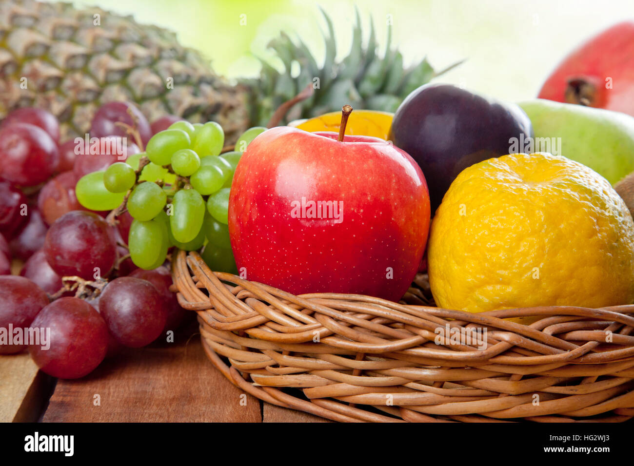 Wicker basket filled with fresh fruits Stock Photo - Alamy