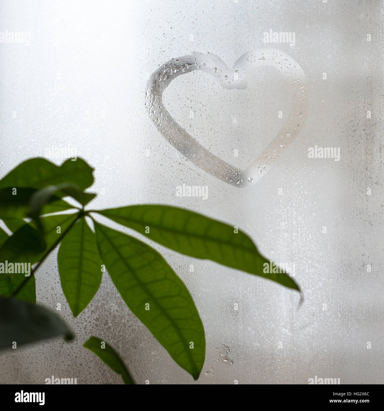 Inscription on the sweaty window glass, shape of heart. Love and ...