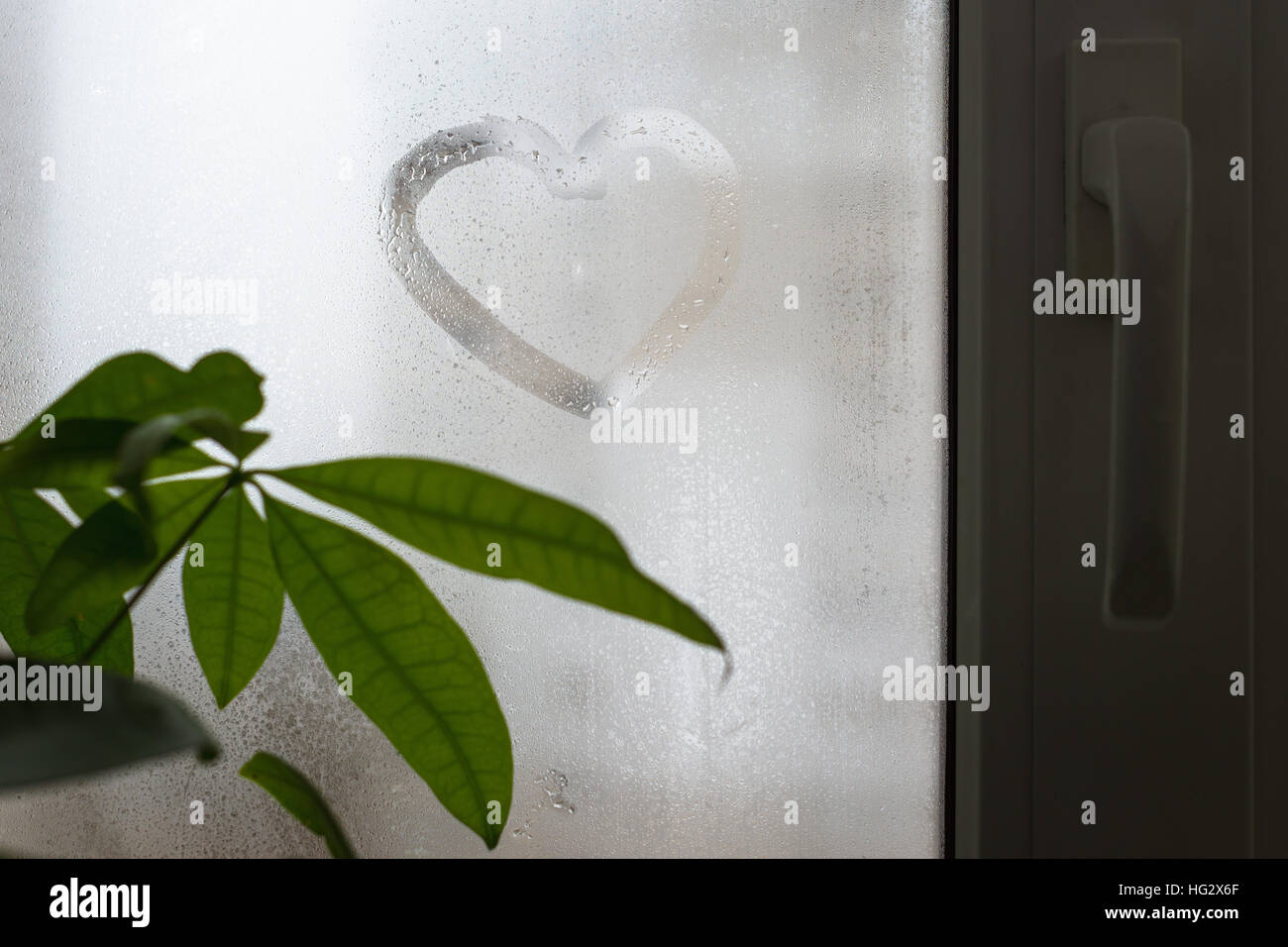 Inscription on the sweaty window glass, shape of heart. Love and ...