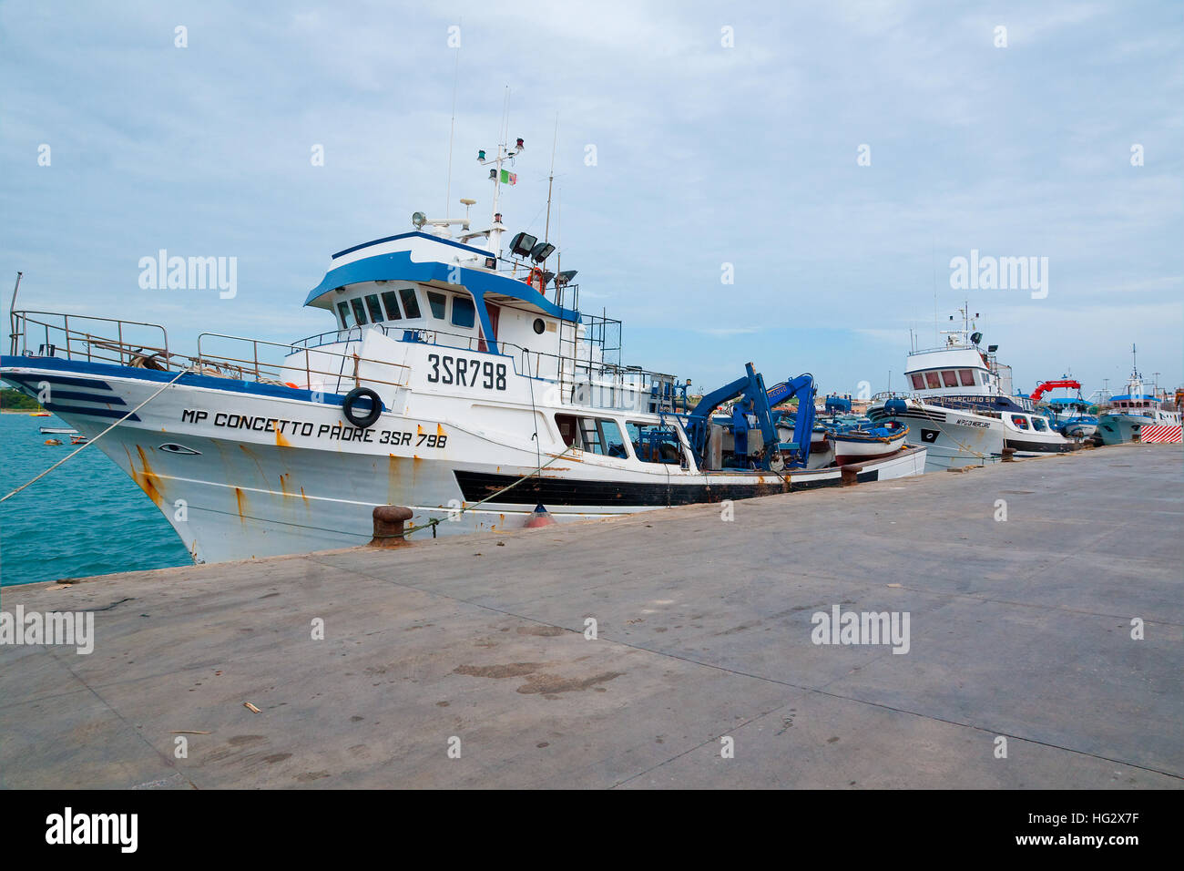 Italian fishing trawlers moored to the quayside in Portopalo, Sicily ...