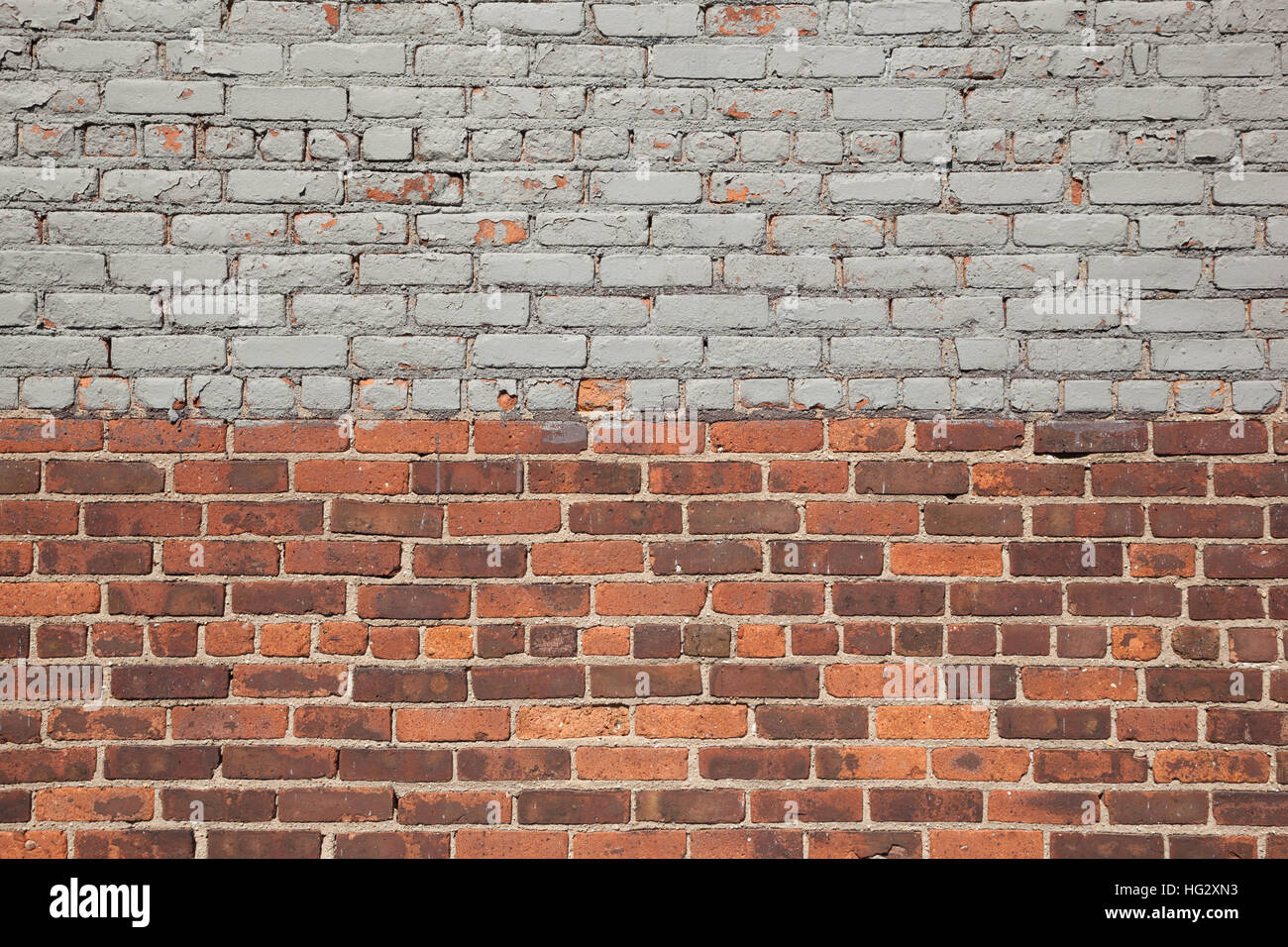 A brick wall is half natural brick and half gray painted brick Stock ...