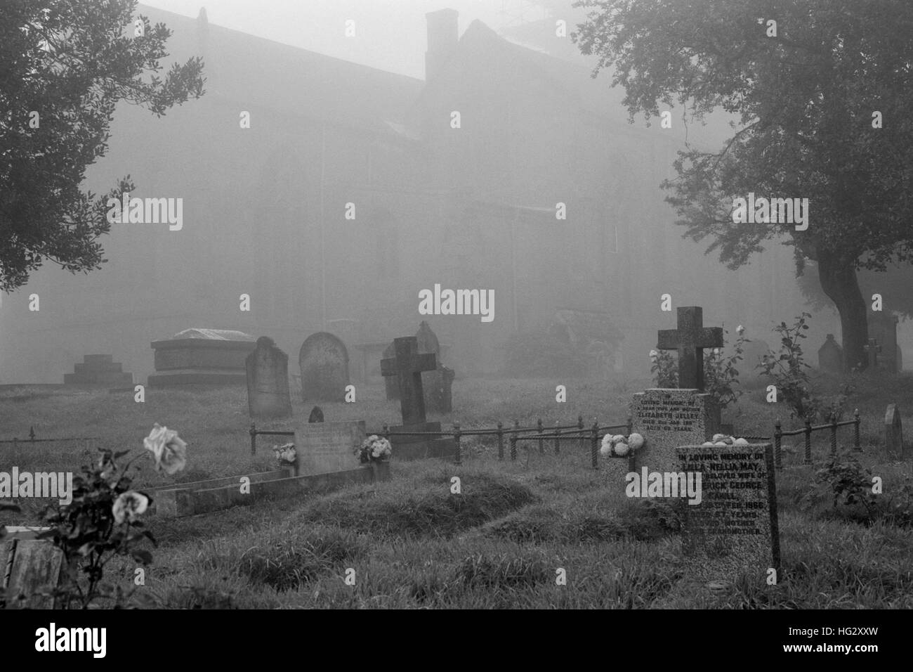 heavy fog giving an ethereal atmosphere shrouding a graveyard england ...