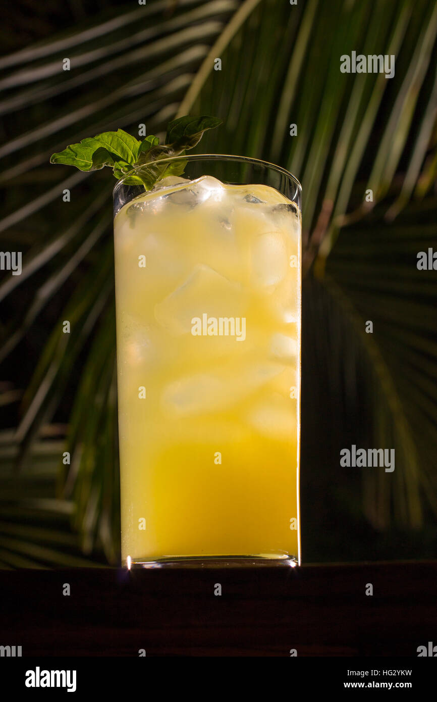 Pineapple Basil Cocktail with Palm Trees in Background Stock Photo - Alamy