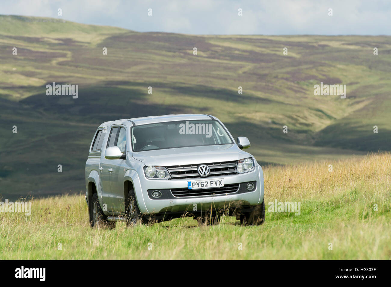 Four wheel drive VW Amarok twin cab pick up driving across upland ...