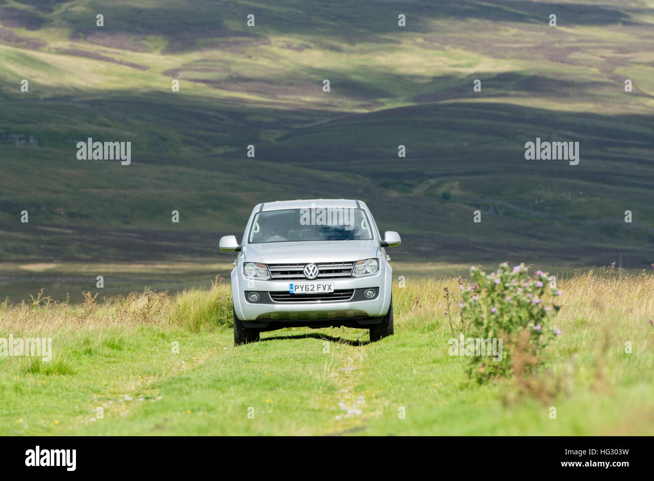 Four wheel drive VW Amarok twin cab pick up driving across upland ...