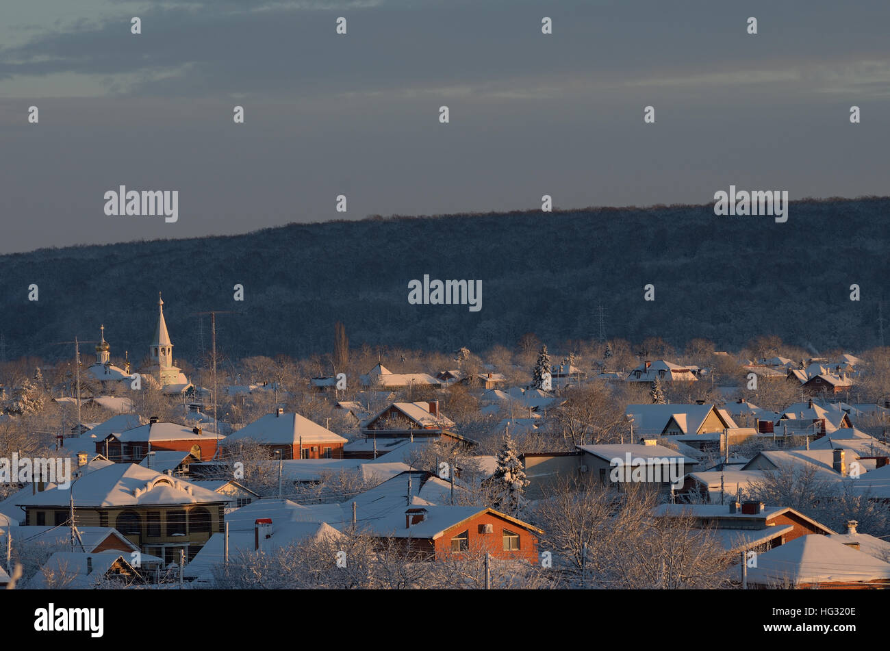 Orthodox tserkov among single-storey houses. Winter evening. After ...