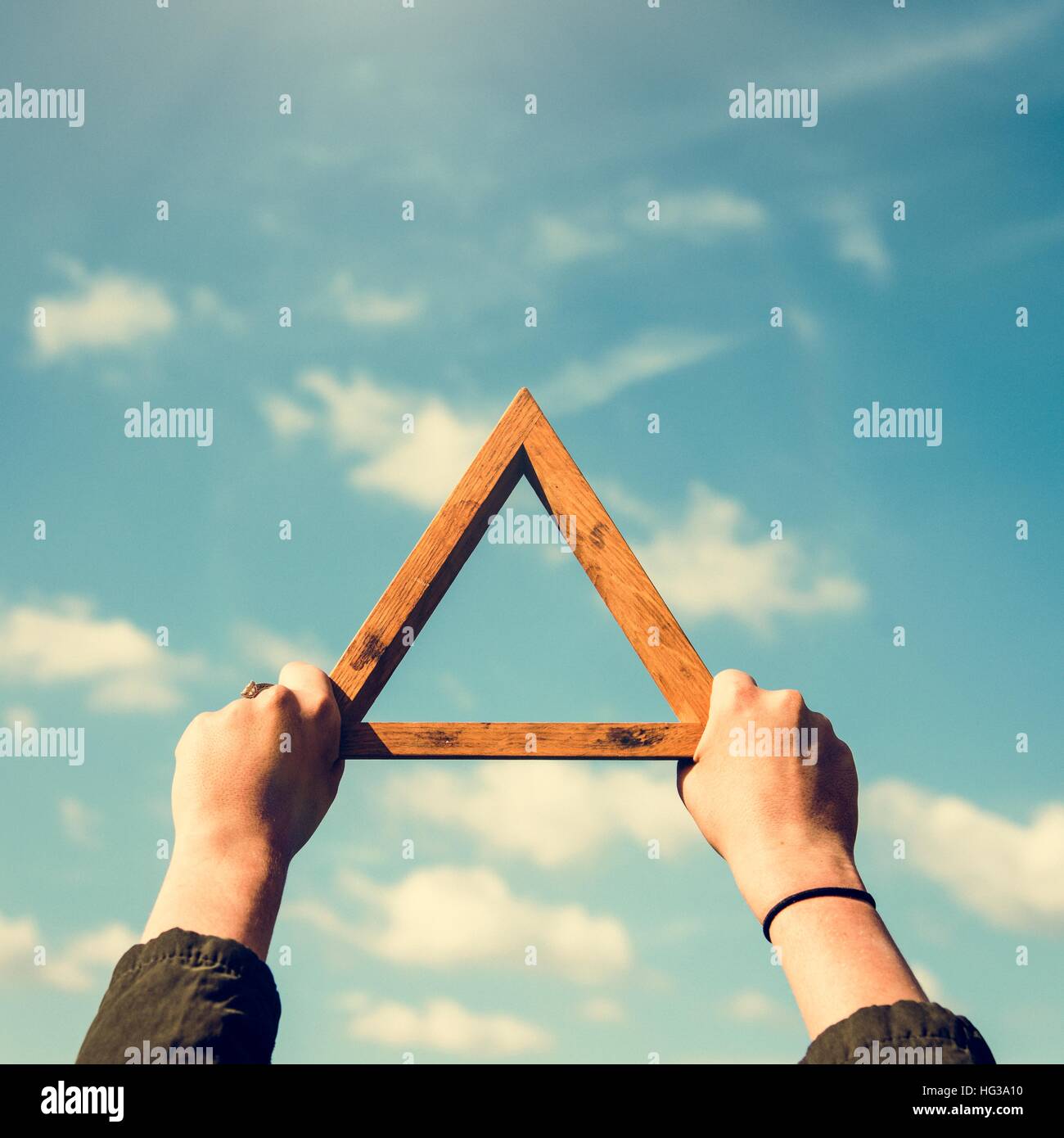 Hands Holding Triangle Symbol Cloudscape Concept Stock Photo - Alamy