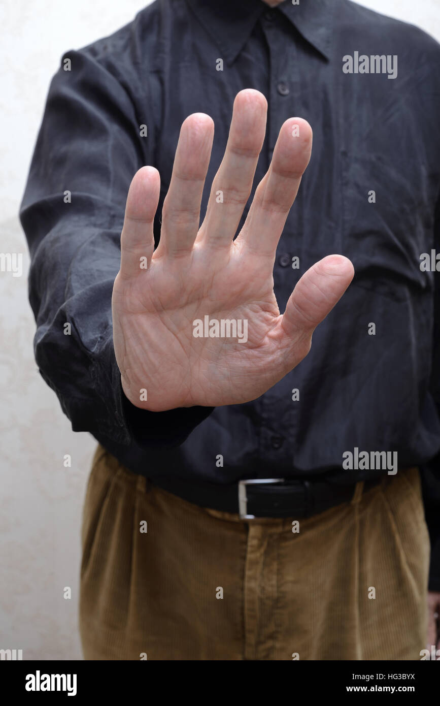 A man saying stop or no with the open hand gesture. Refusing to take ...