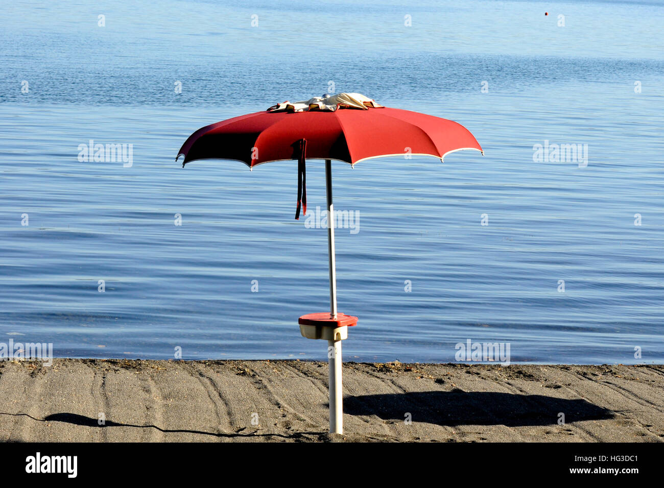 A single umbrella on the beach under sun of the early morning Stock ...