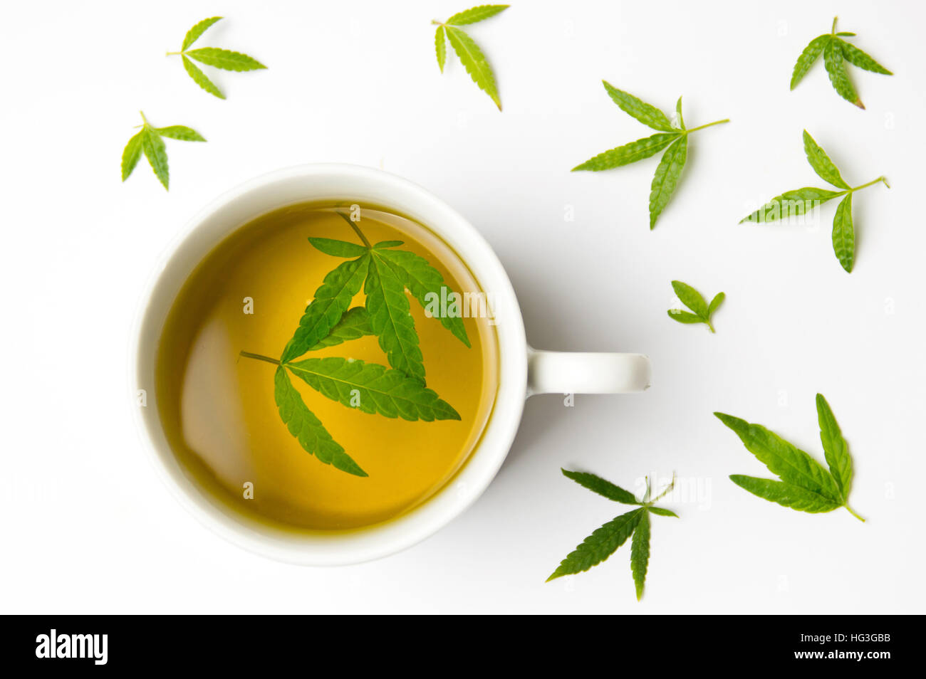 Marijuana herbal tea and green cannabis leaves Stock Photo - Alamy