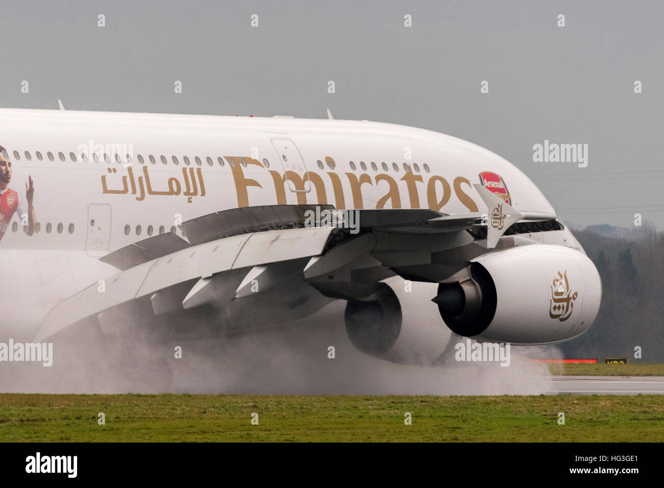 Emirates A380-800 airbus landing in the rain. Arsenal football team ...
