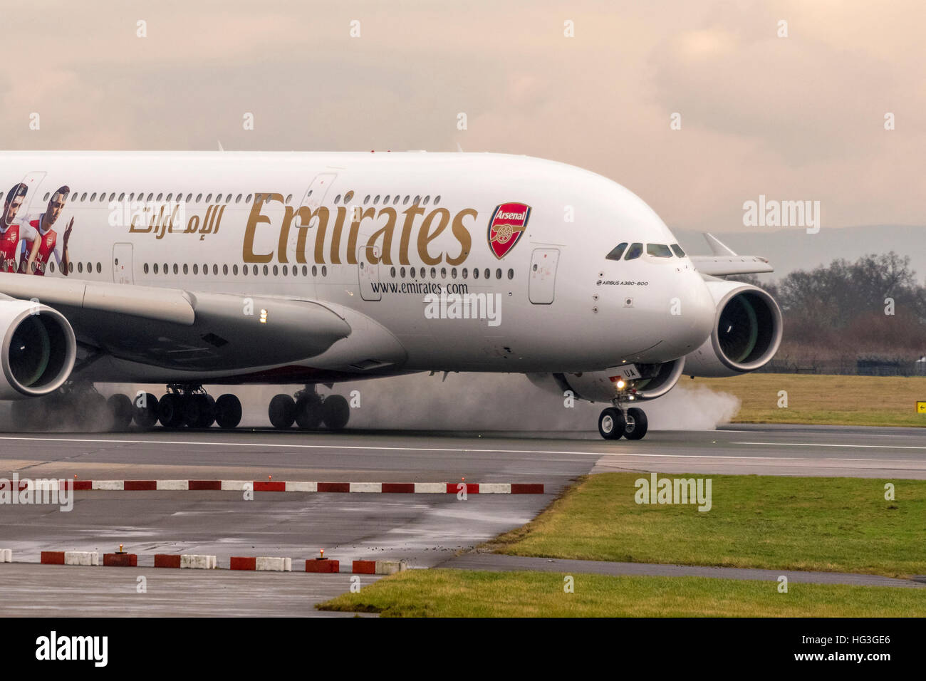 Emirates A380-800 airbus landing in the rain. Arsenal football team ...