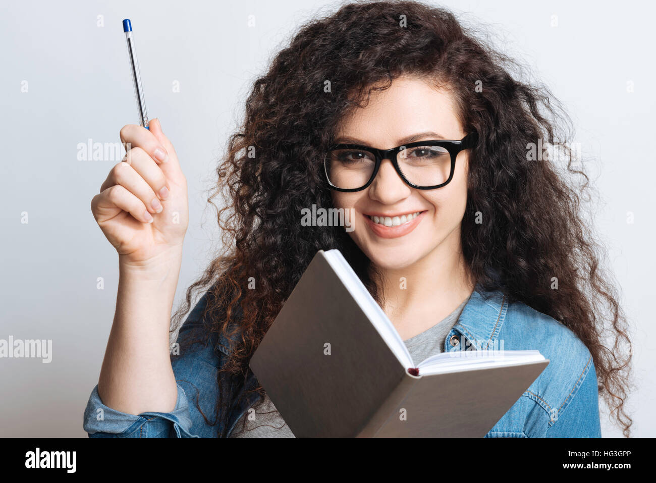 Happy looking girl creating something Stock Photo - Alamy