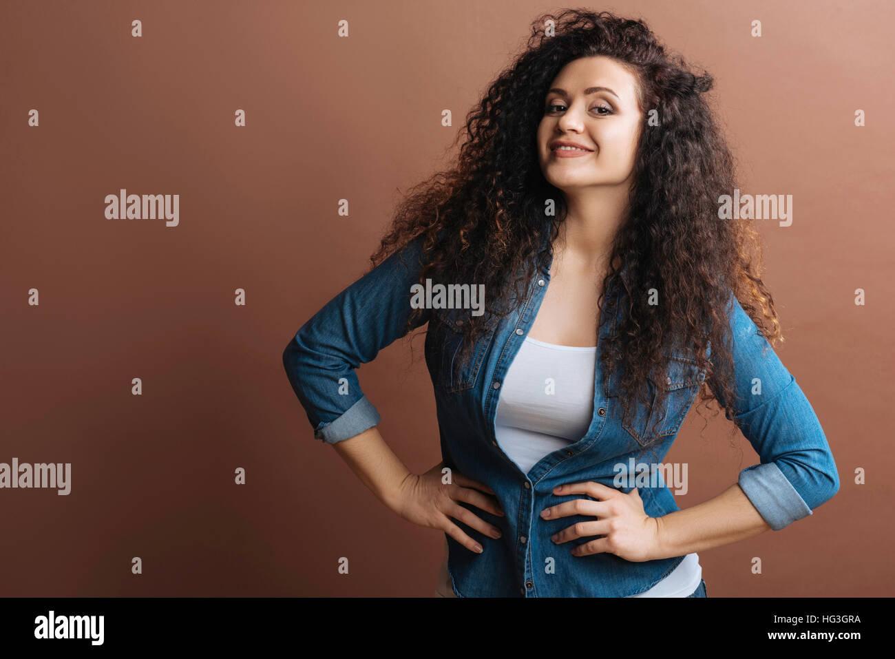 Satisficed looking girl posing on camera Stock Photo - Alamy