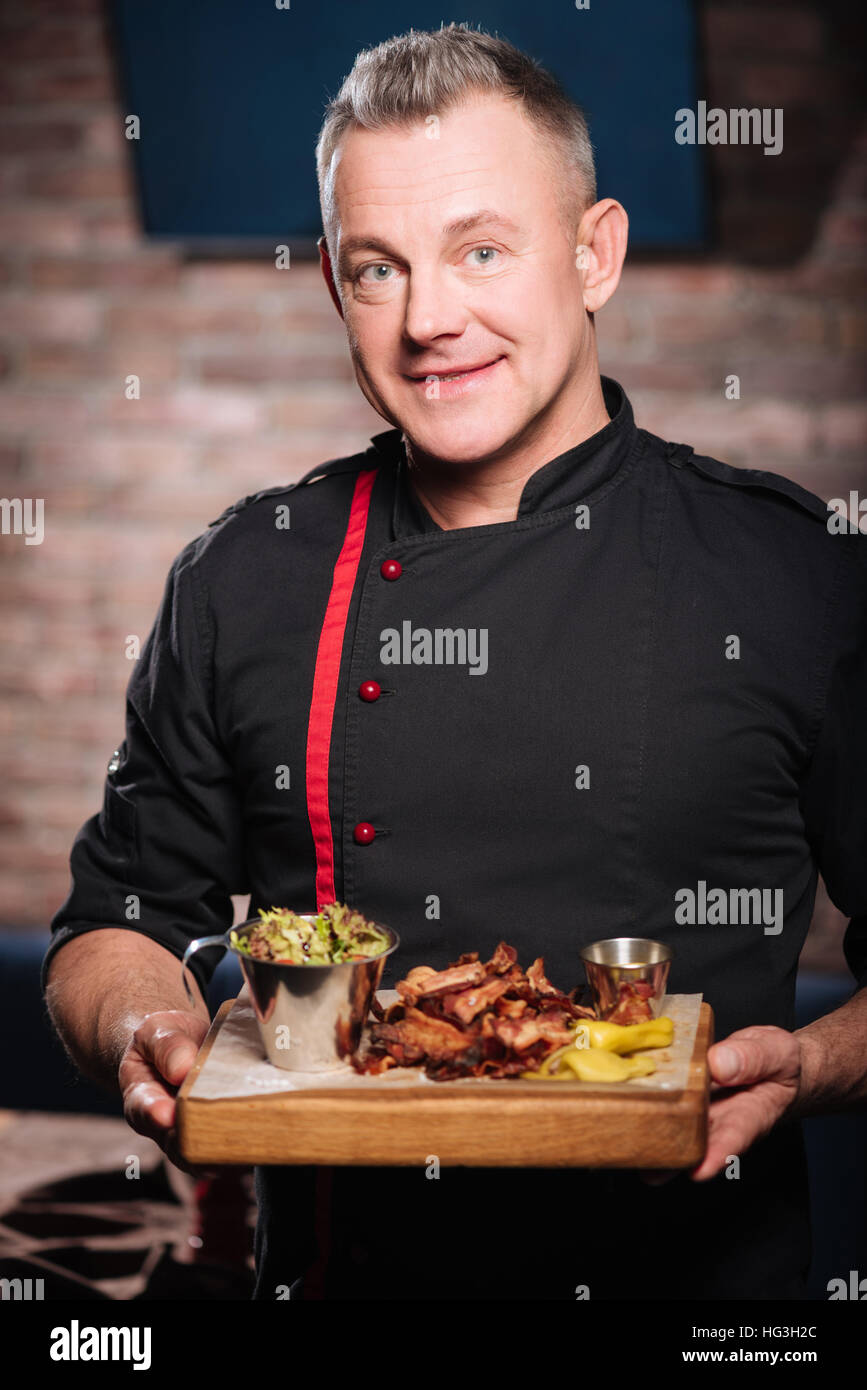 Surprised man holding a tray with bacon Stock Photo - Alamy
