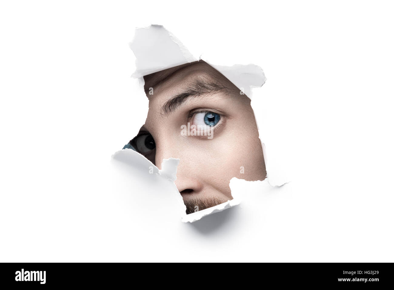 Man Looking Through White Ripped Paper Hole Stock Photo - Alamy