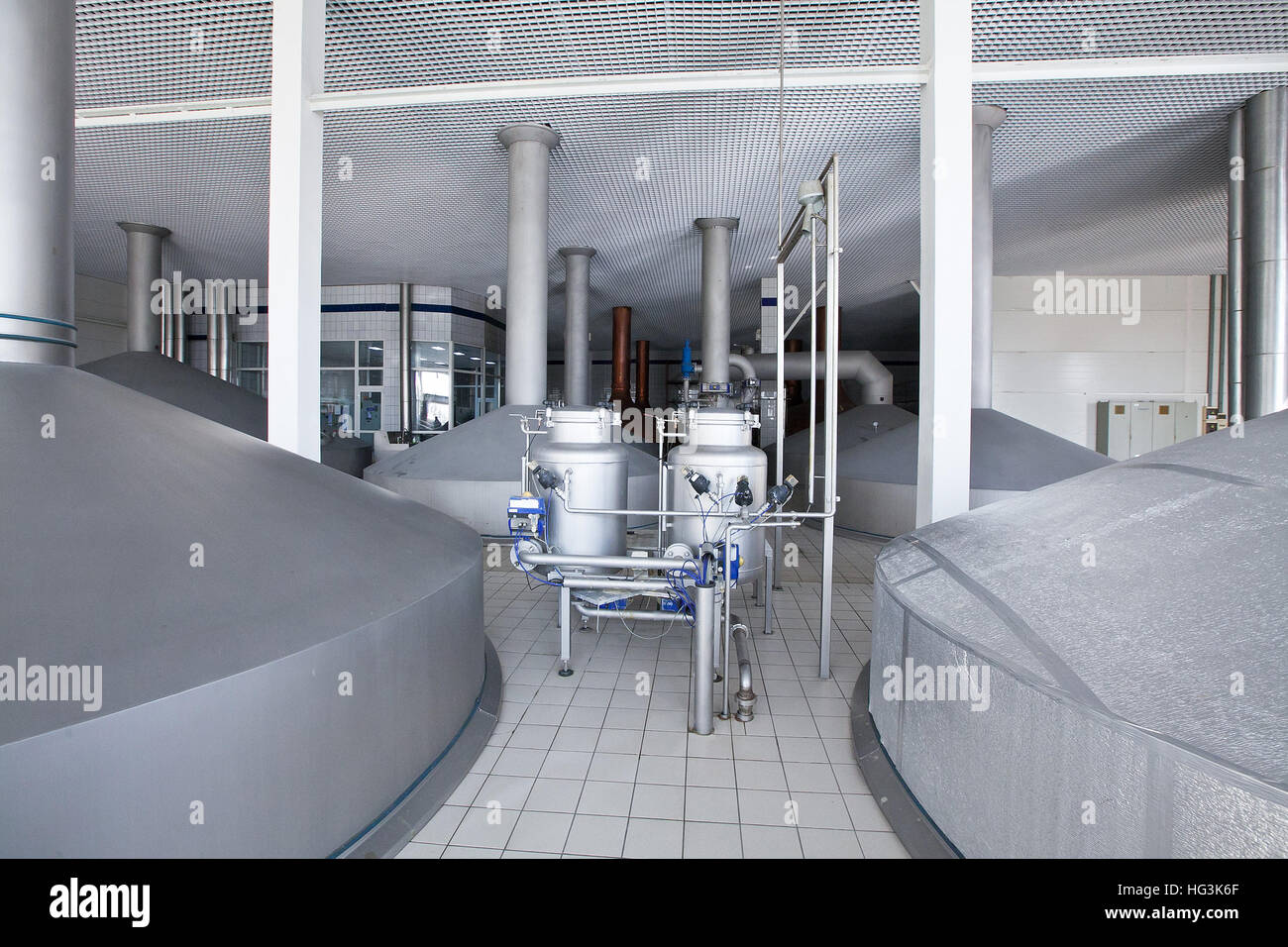 Beer factory with large storage tanks inside Stock Photo - Alamy