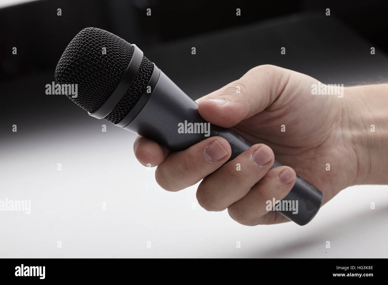 Microphone in a man's hand Stock Photo - Alamy