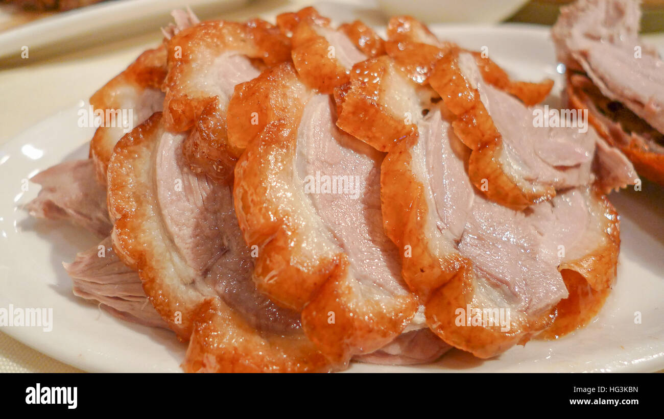 Roast Peking duck chinese cuisine sliced portions on plate Stock Photo ...