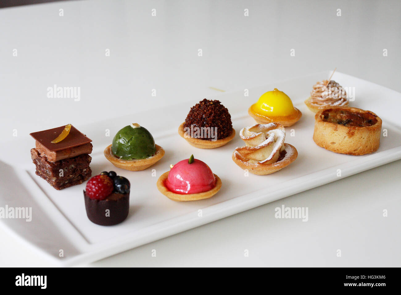 Assorted pastries on white dish and white background Stock Photo - Alamy