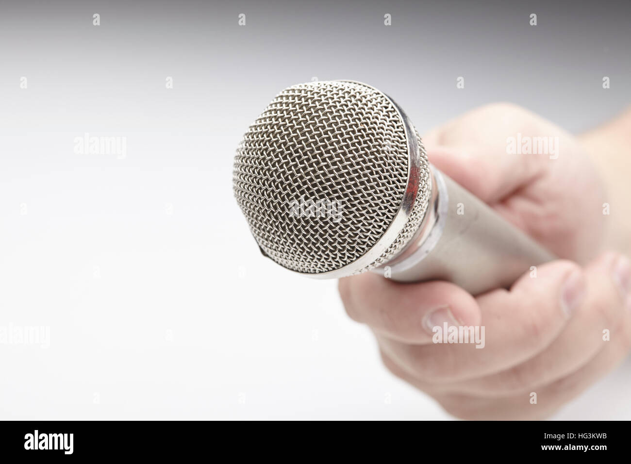 Microphone in a man's hand Stock Photo - Alamy