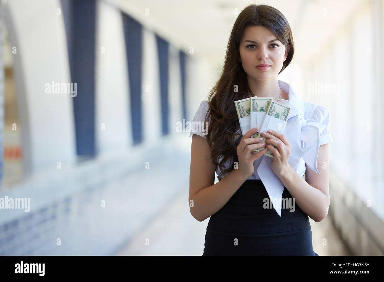 business woman holding money Stock Photo - Alamy
