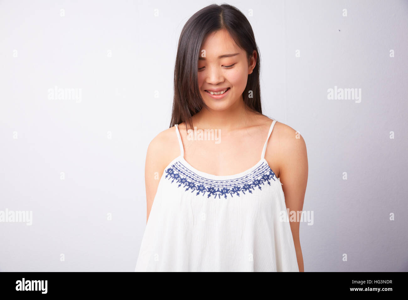 smiling Chinese woman in a white top Stock Photo - Alamy