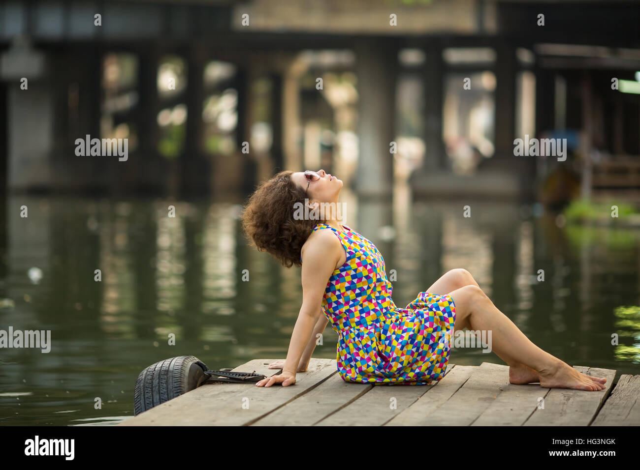 Young beautiful Asian woman on a river dock Stock Photo - Alamy