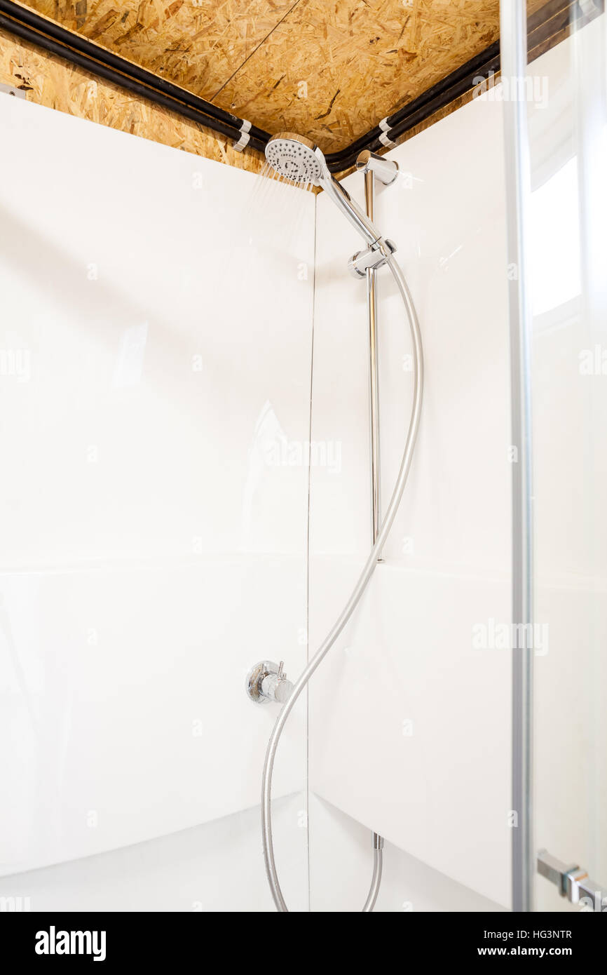 in a small place, there is a shower booth in the corner of the bathroom ...