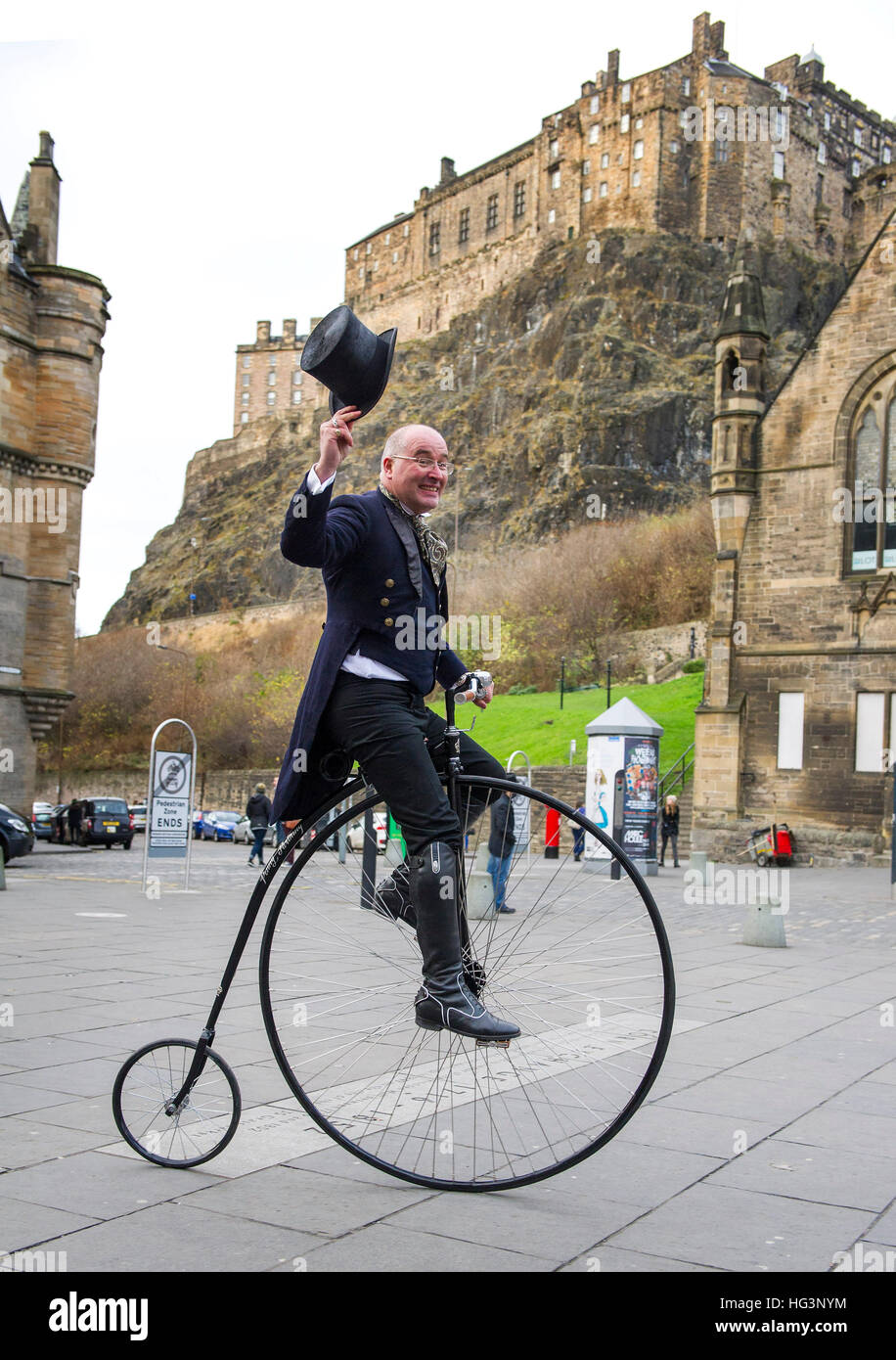 Mr Phoebus rides his Penny Farthing past in Edinburgh's Grassmarket ...
