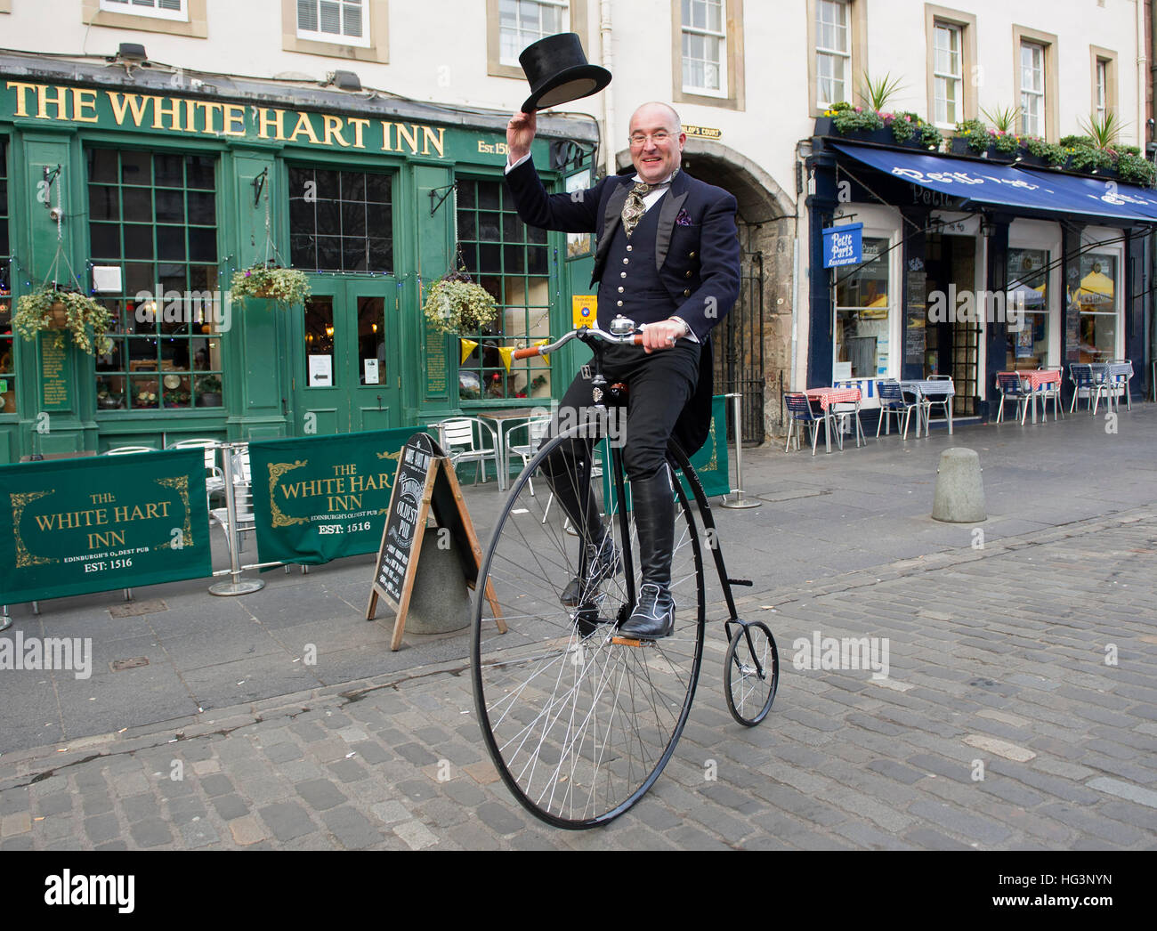 Mr Phoebus rides his Penny Farthing past the White Hart Inn on ...