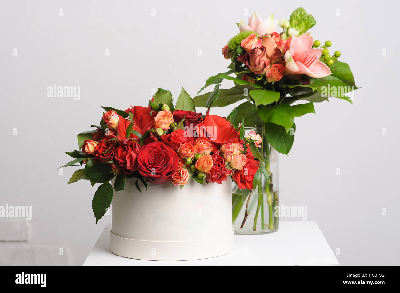 flower arrangement on table. Bouquet of roses in a paper box. vase in ...