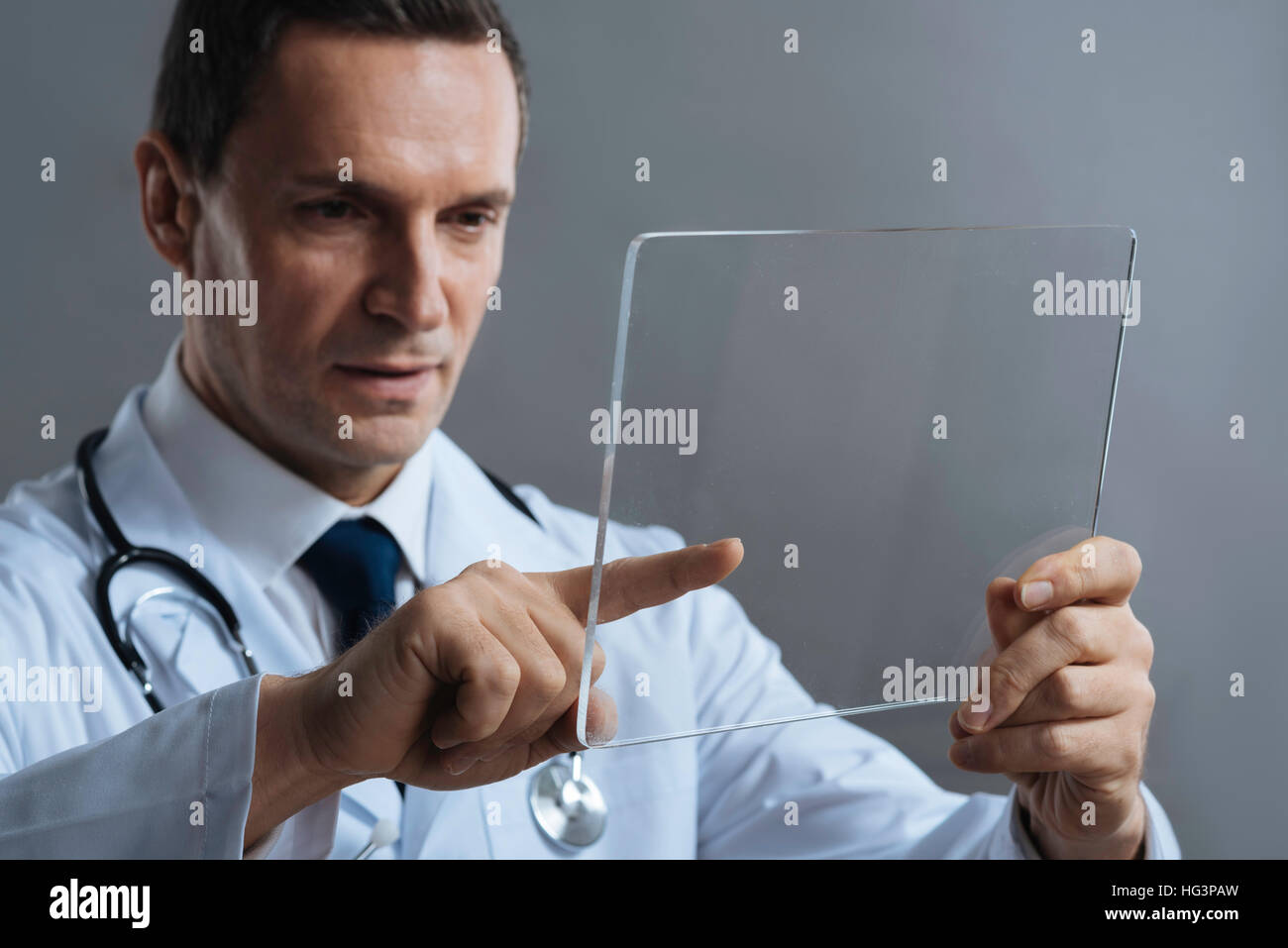 Concentrated doctor using special glass Stock Photo - Alamy